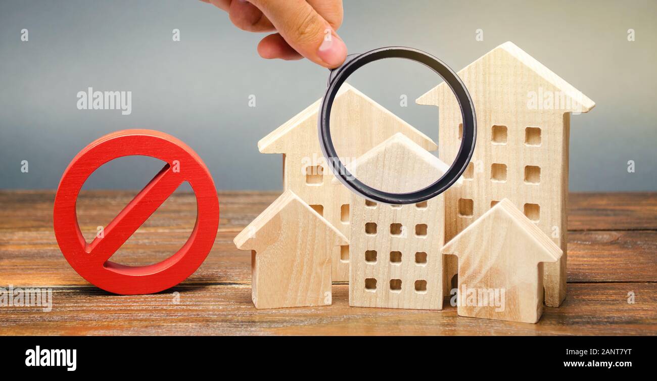 Wooden houses and a prohibition sign. Inaccessible and expensive ...