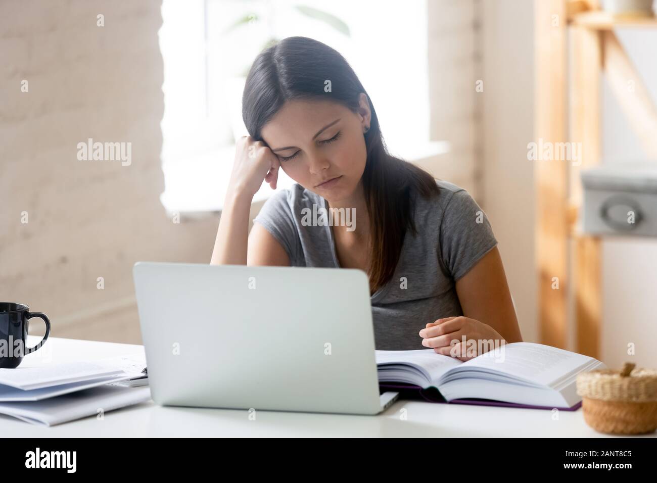 Overworked tired female student fell asleep seated at table Stock Photo ...