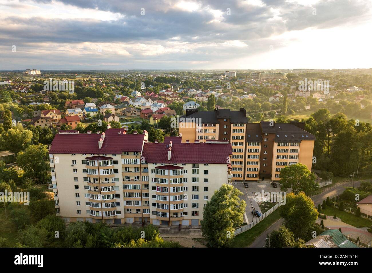 Aerial view of multistory apartment buildings in green residential area ...