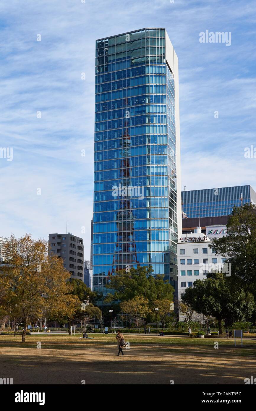 The iconic Tokyo Tower is reflected in the glass windows of a Tokyo office building called Shiba ...