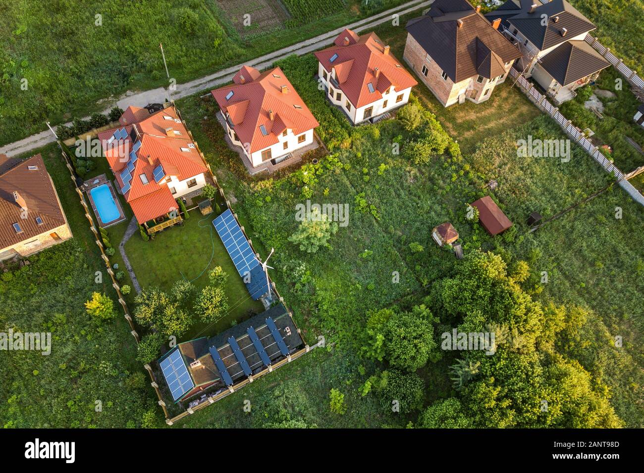 Aerial view of rural residential area with private homes between green ...