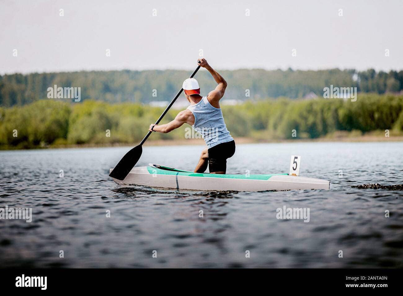 athlete canoeist rowing in lake. canoeing competition race Stock Photo ...