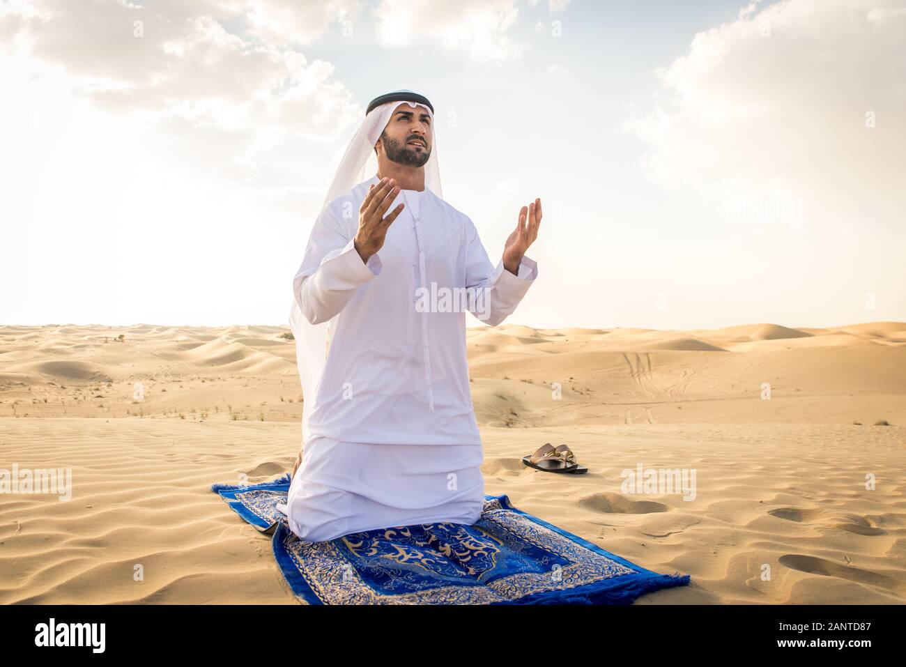 Arabian men witk kandora walking in the desert - Portrait of two middle ...