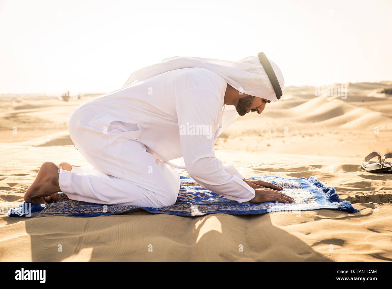Arabian men witk kandora walking in the desert - Portrait of two middle ...