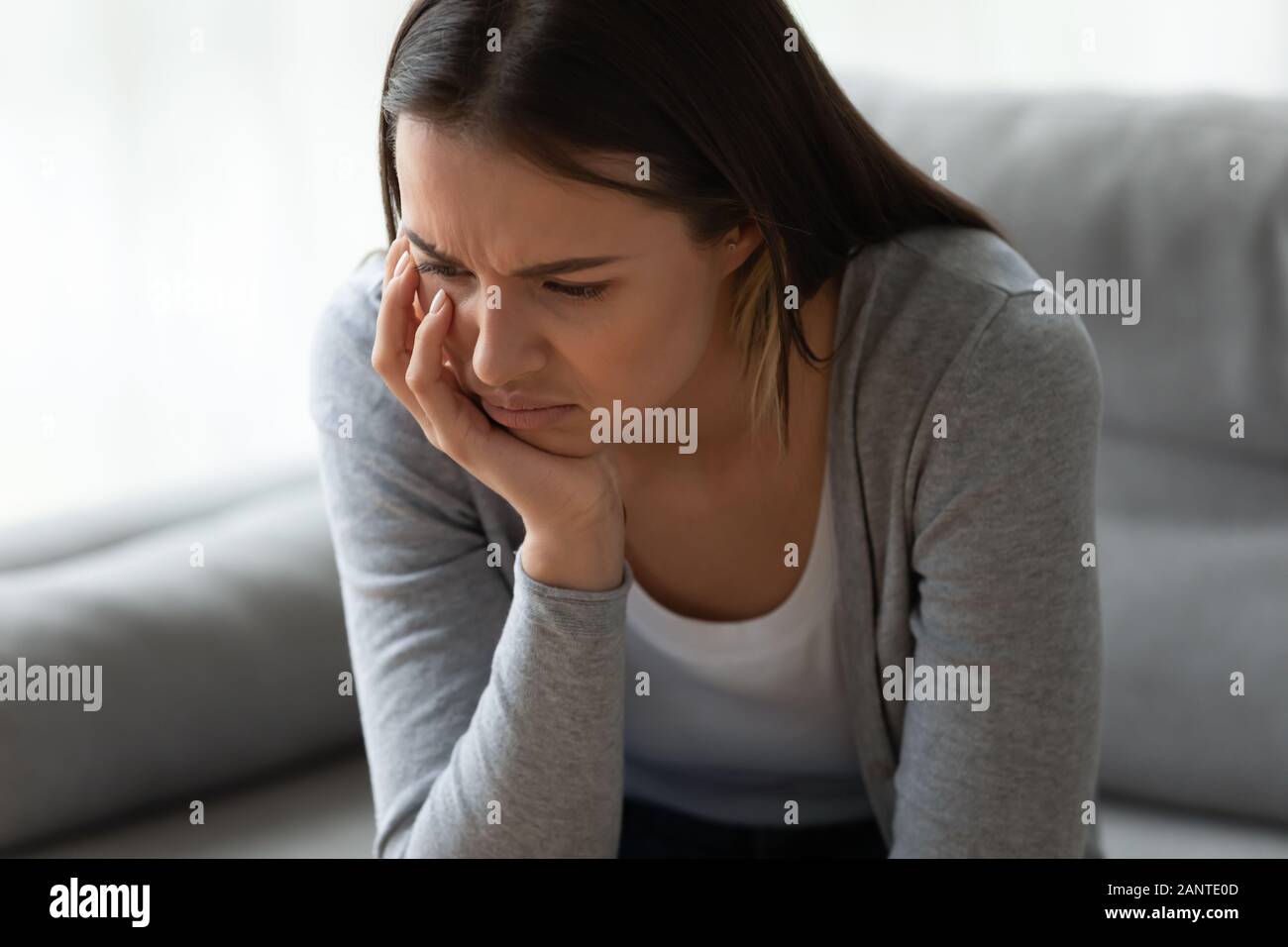 Unhappy depressed young woman thinking about problem alone close up ...