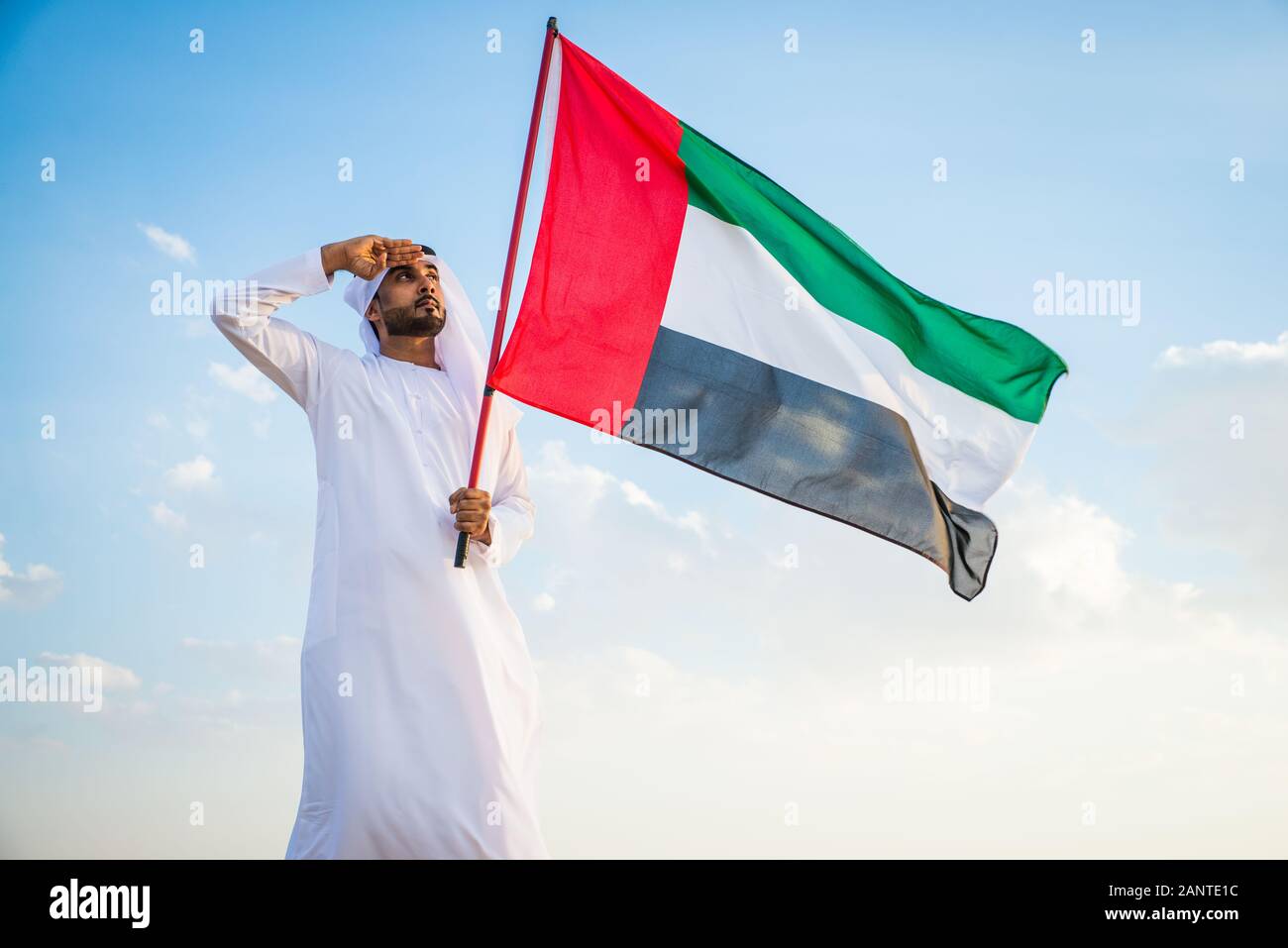 Arabian men witk kandora walking in the desert - Portrait of two middle ...