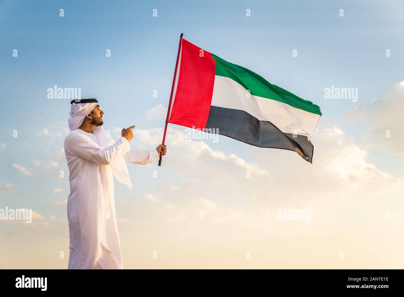 Arabian men witk kandora walking in the desert - Portrait of two middle ...