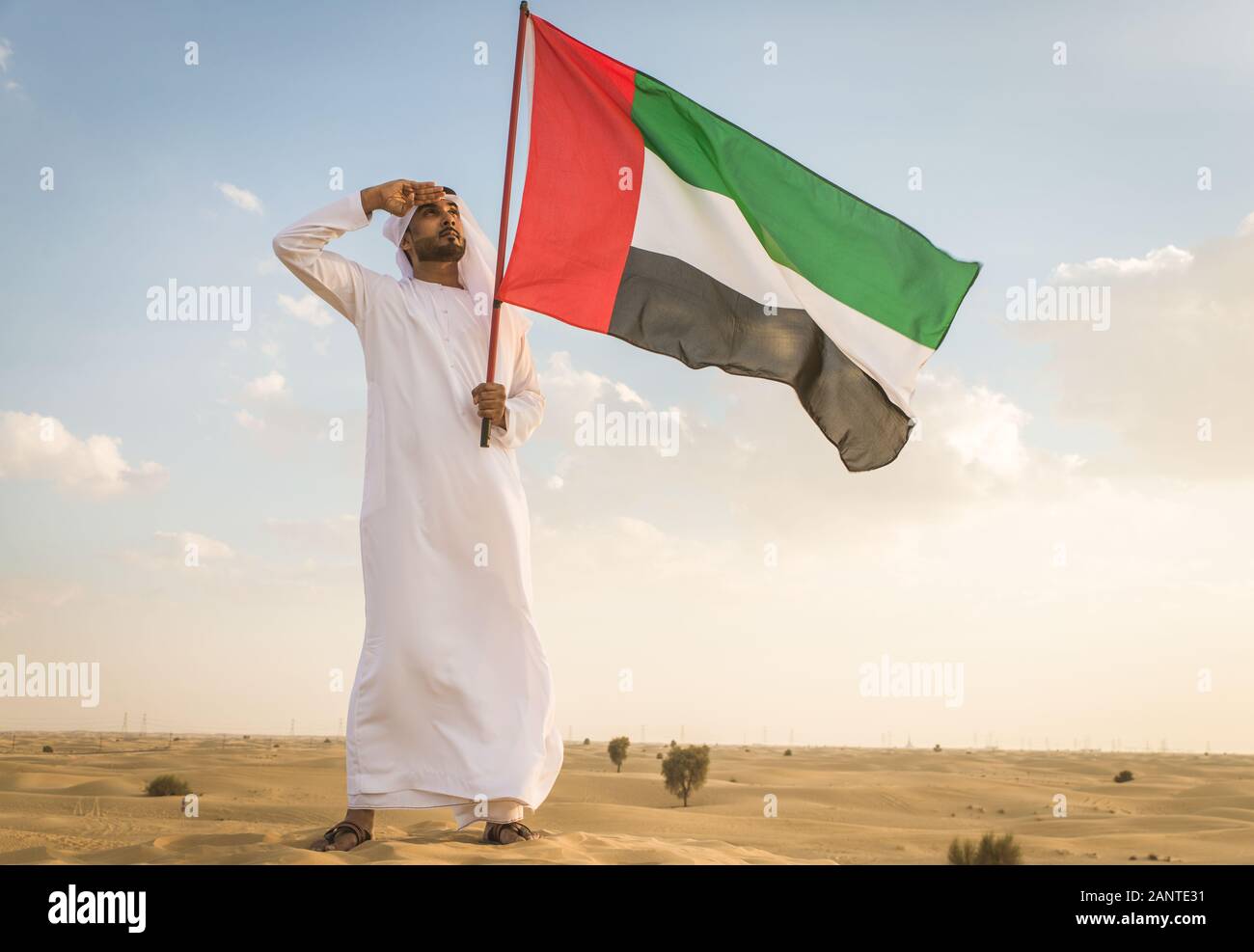 Arabian men witk kandora walking in the desert - Portrait of two middle ...