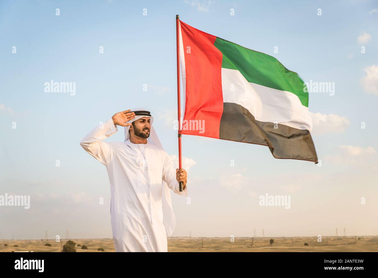 Arabian men witk kandora walking in the desert - Portrait of two middle ...