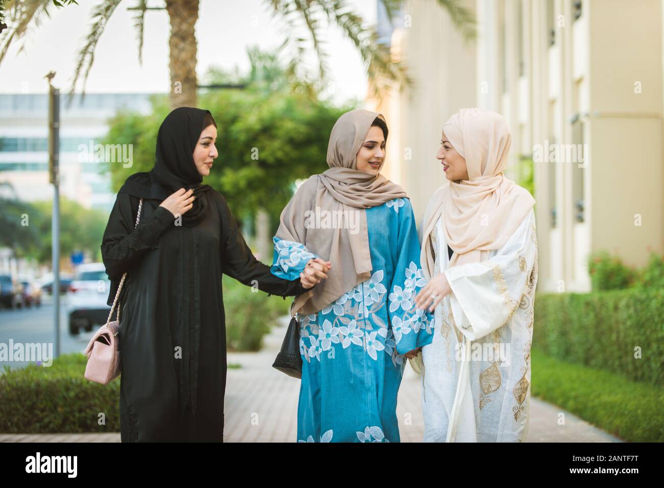 Arabic women with abaya bonding and having fun outdoors - Happy ...