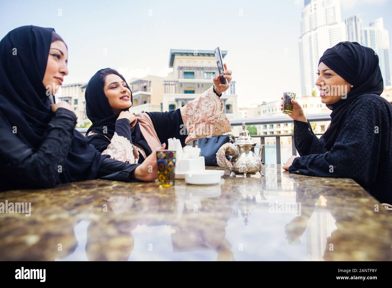 Arabic women with abaya bonding and having fun outdoors - Happy ...