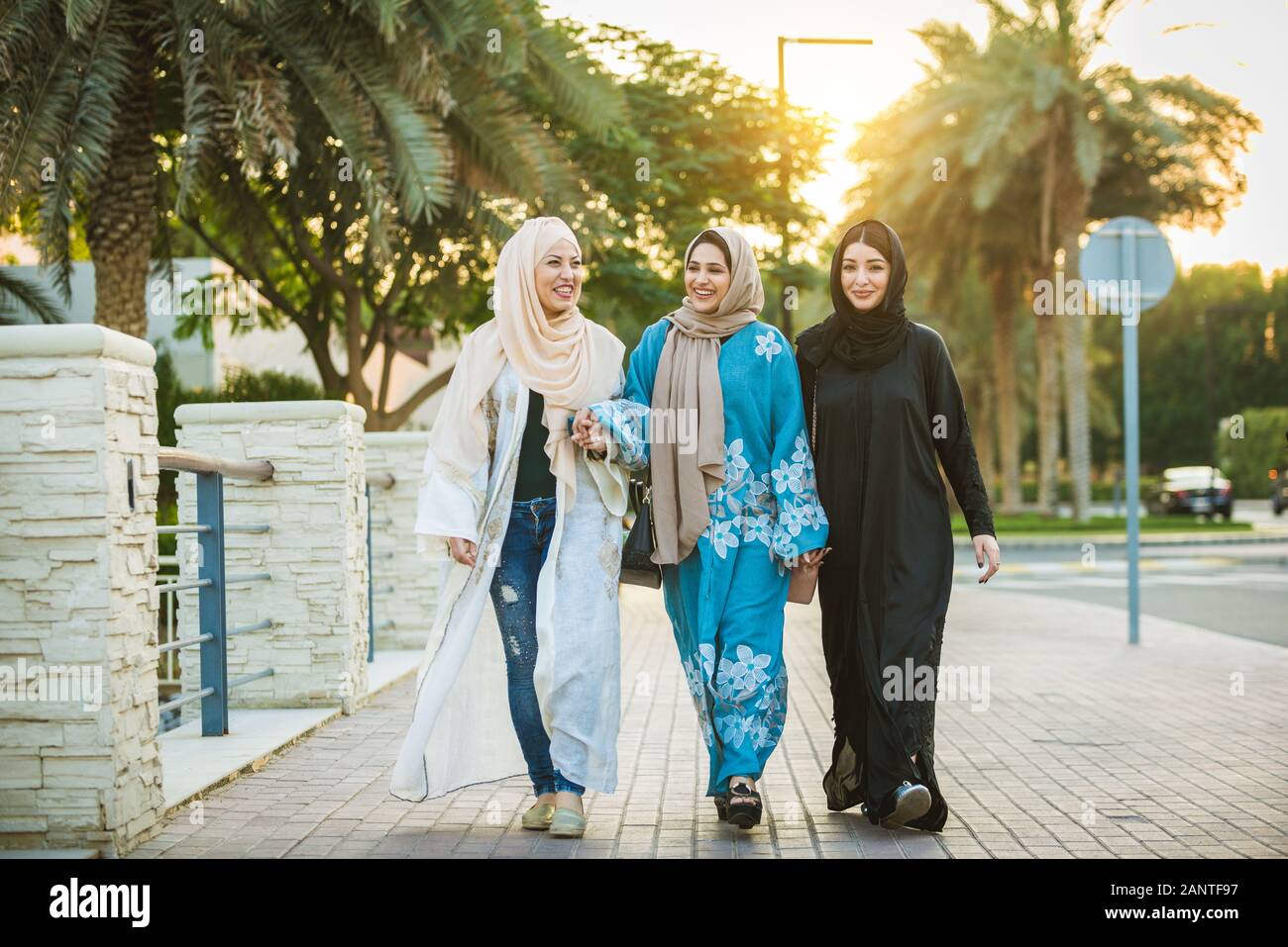 Arabic women with abaya bonding and having fun outdoors - Happy ...