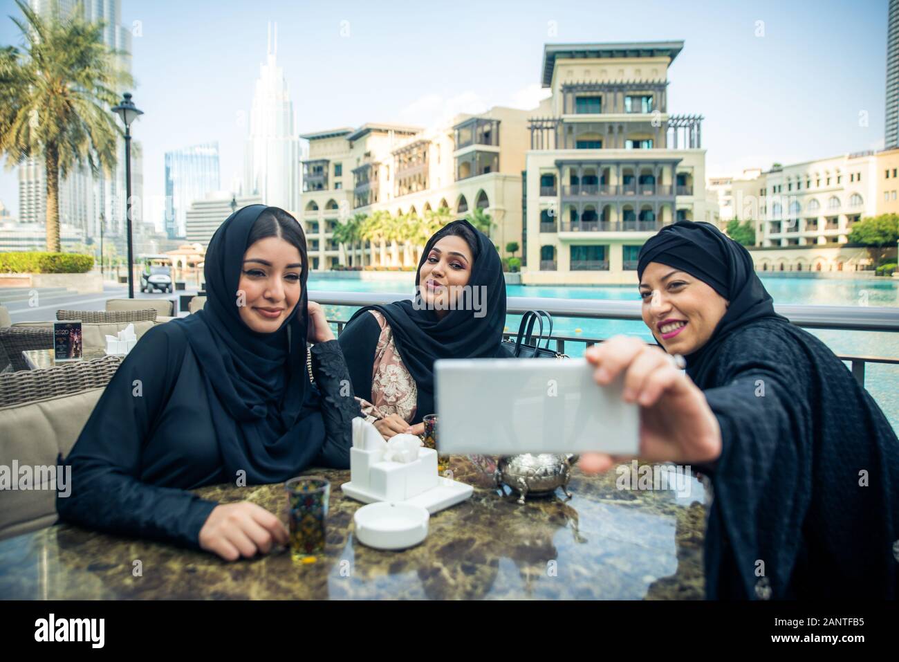Arabic women with abaya bonding and having fun outdoors - Happy ...