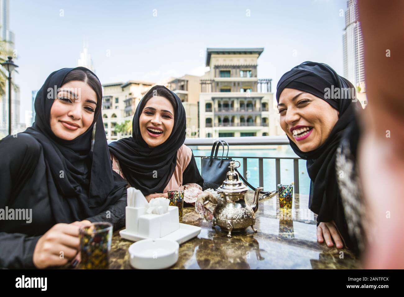 Arabic women with abaya bonding and having fun outdoors - Happy ...
