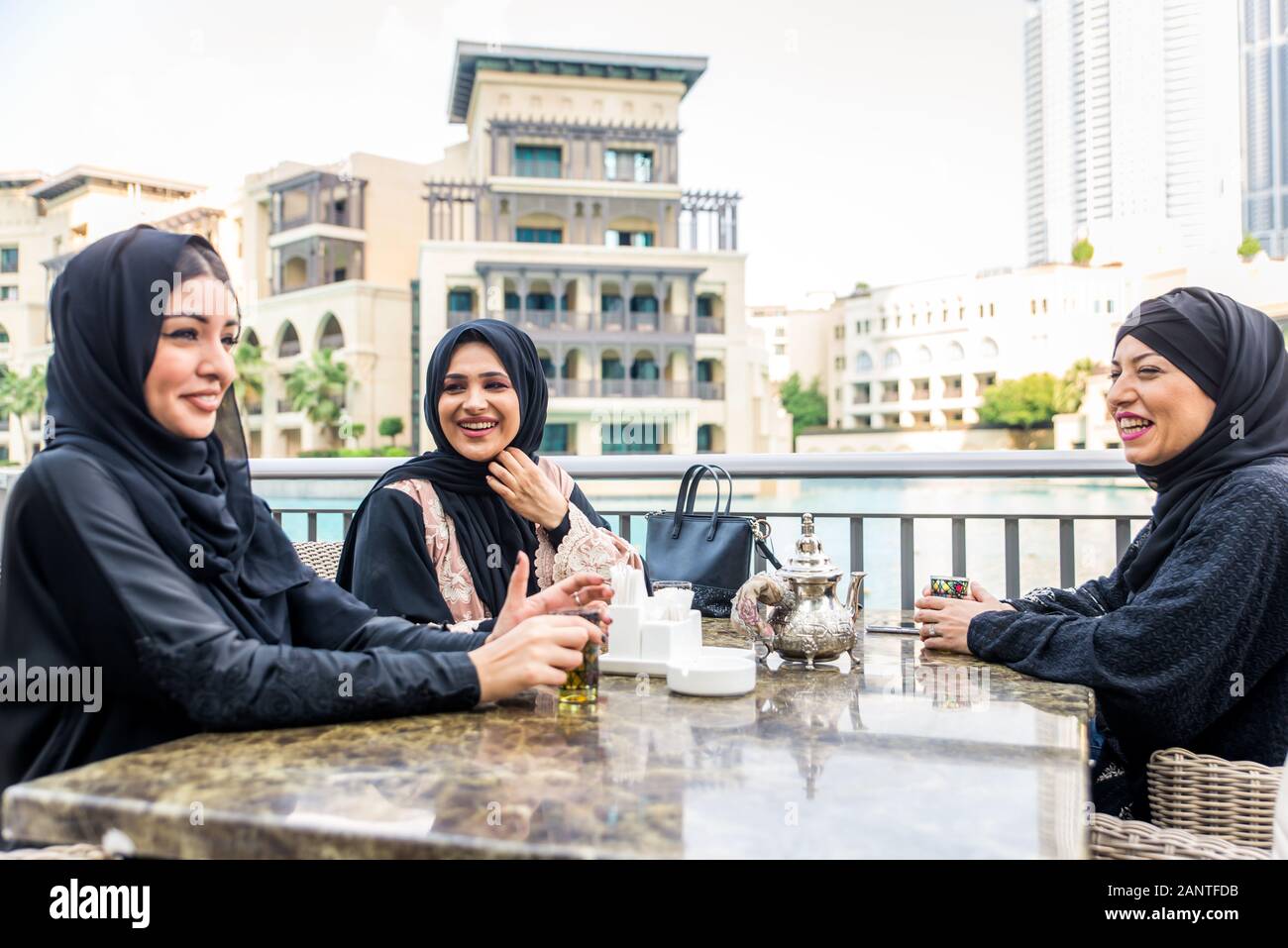 Arabic women with abaya bonding and having fun outdoors - Happy ...