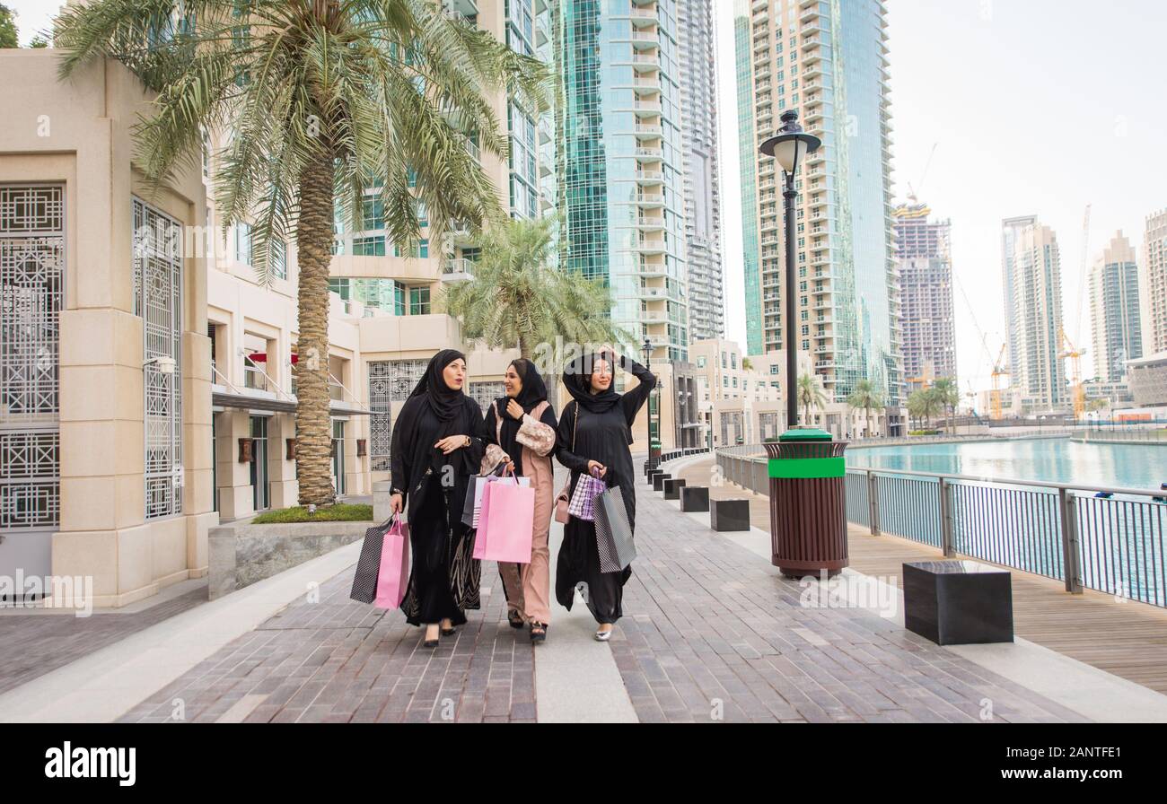 Arabic women with abaya bonding and having fun outdoors - Happy ...