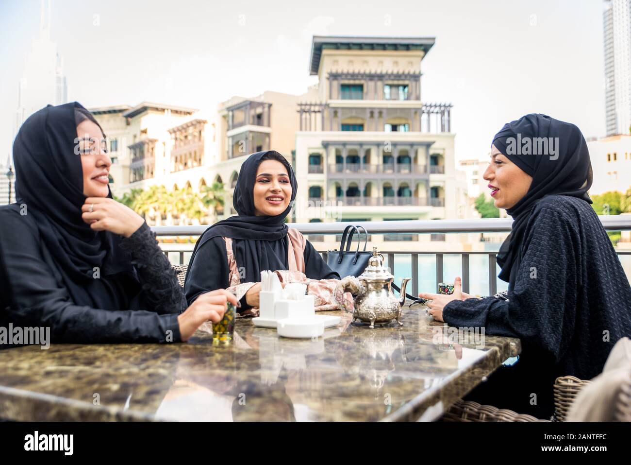 Arabic women with abaya bonding and having fun outdoors - Happy ...