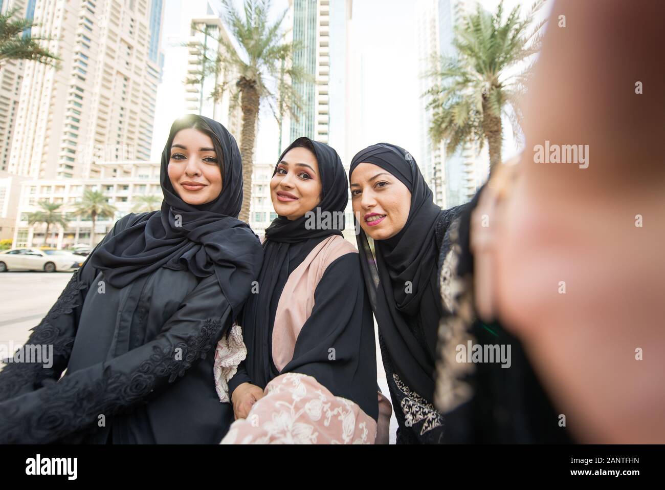 Arabic women with abaya bonding and having fun outdoors - Happy ...