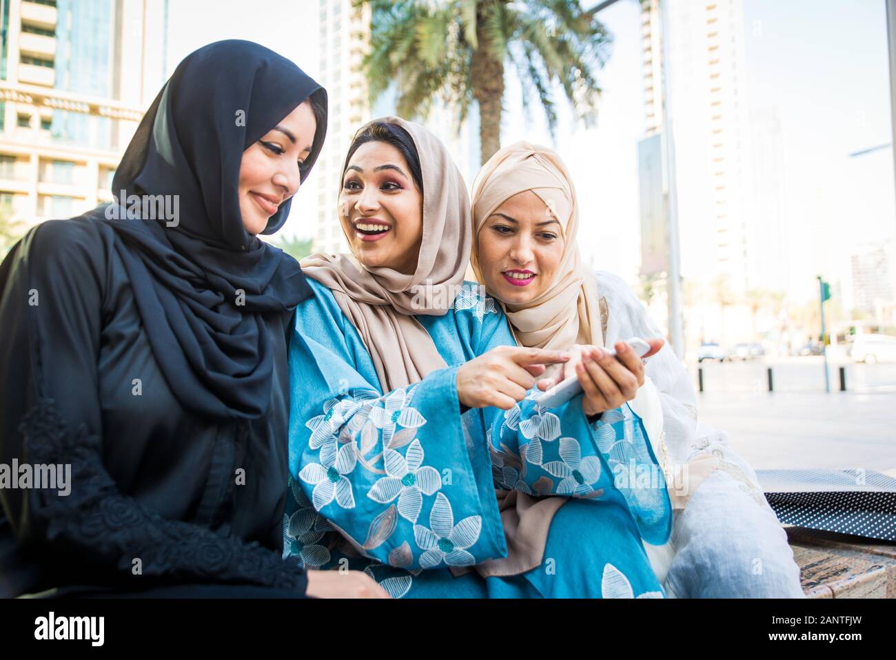 Arabic women with abaya bonding and having fun outdoors - Happy ...