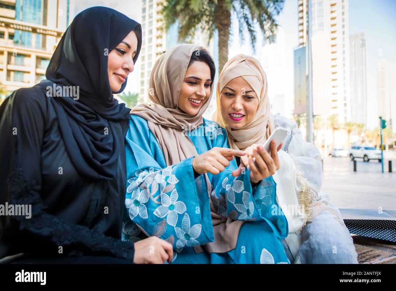 Arabic women with abaya bonding and having fun outdoors - Happy ...