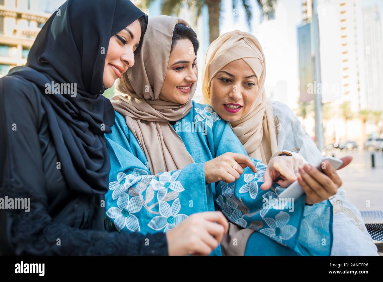 Arabic women with abaya bonding and having fun outdoors - Happy ...