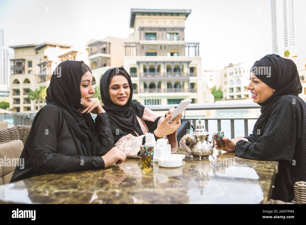 Arabic women with abaya bonding and having fun outdoors - Happy ...