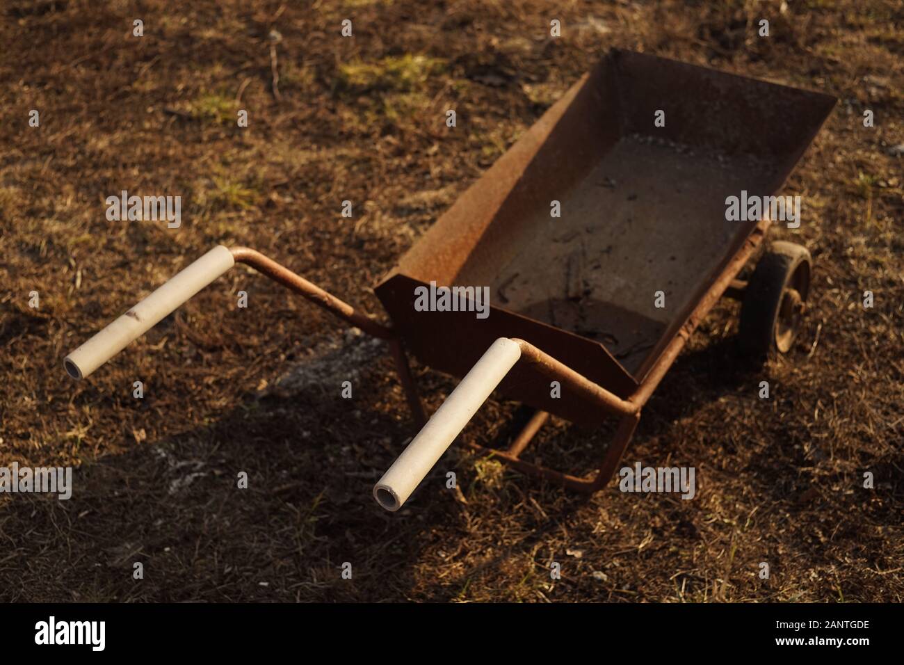 Old rusty trolley on wheels standing on the ground with dry grass Stock ...