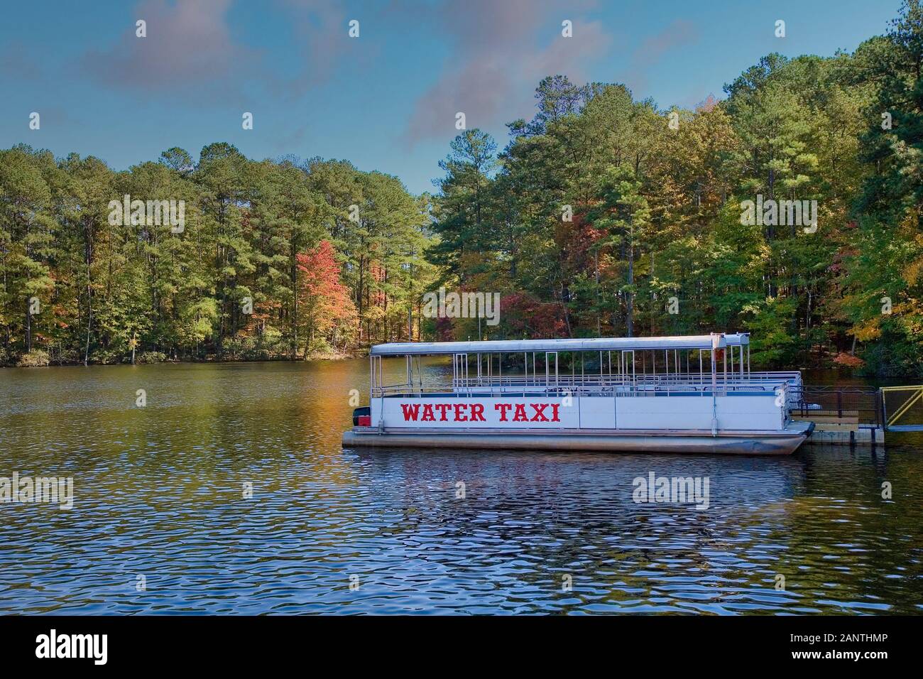 A water taxi by the shore in a tranquil lake Stock Photo - Alamy