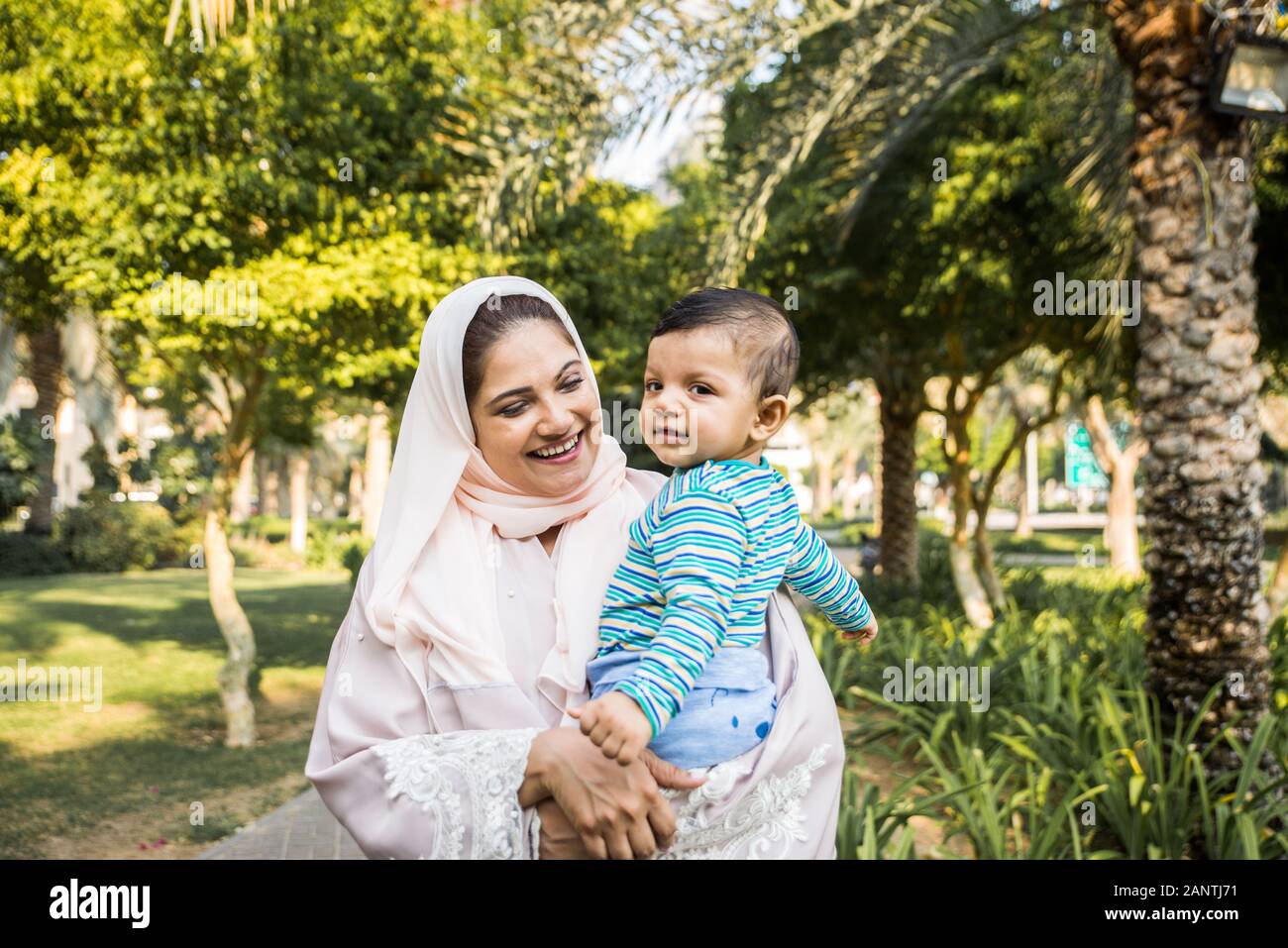 Middle eastern family with traditional dress having fun outdoors ...