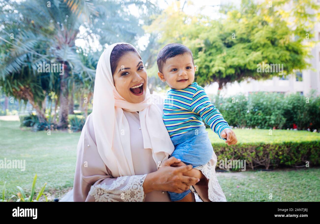 Middle eastern family with traditional dress having fun outdoors ...