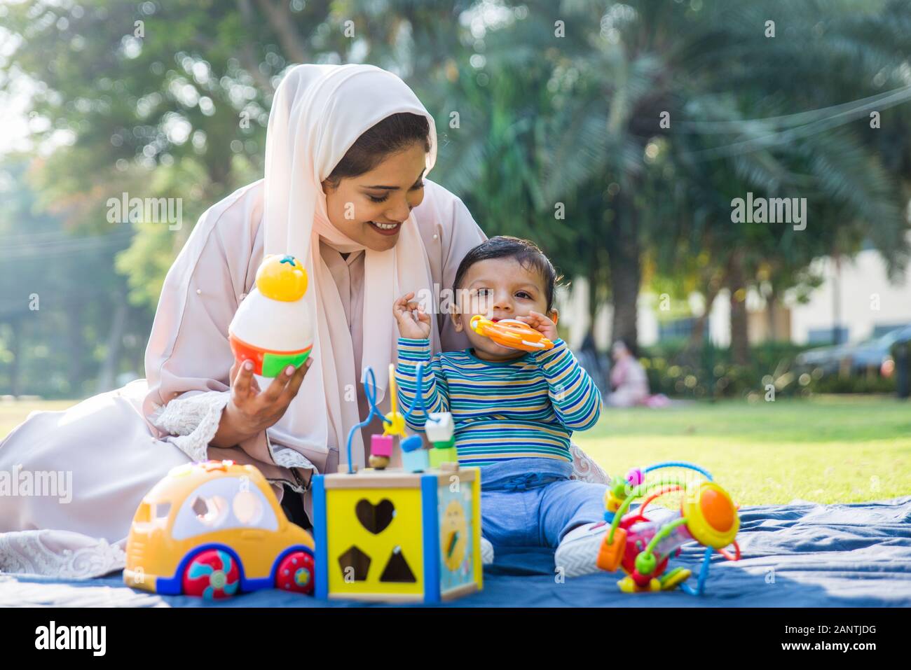Middle eastern family with traditional dress having fun outdoors ...
