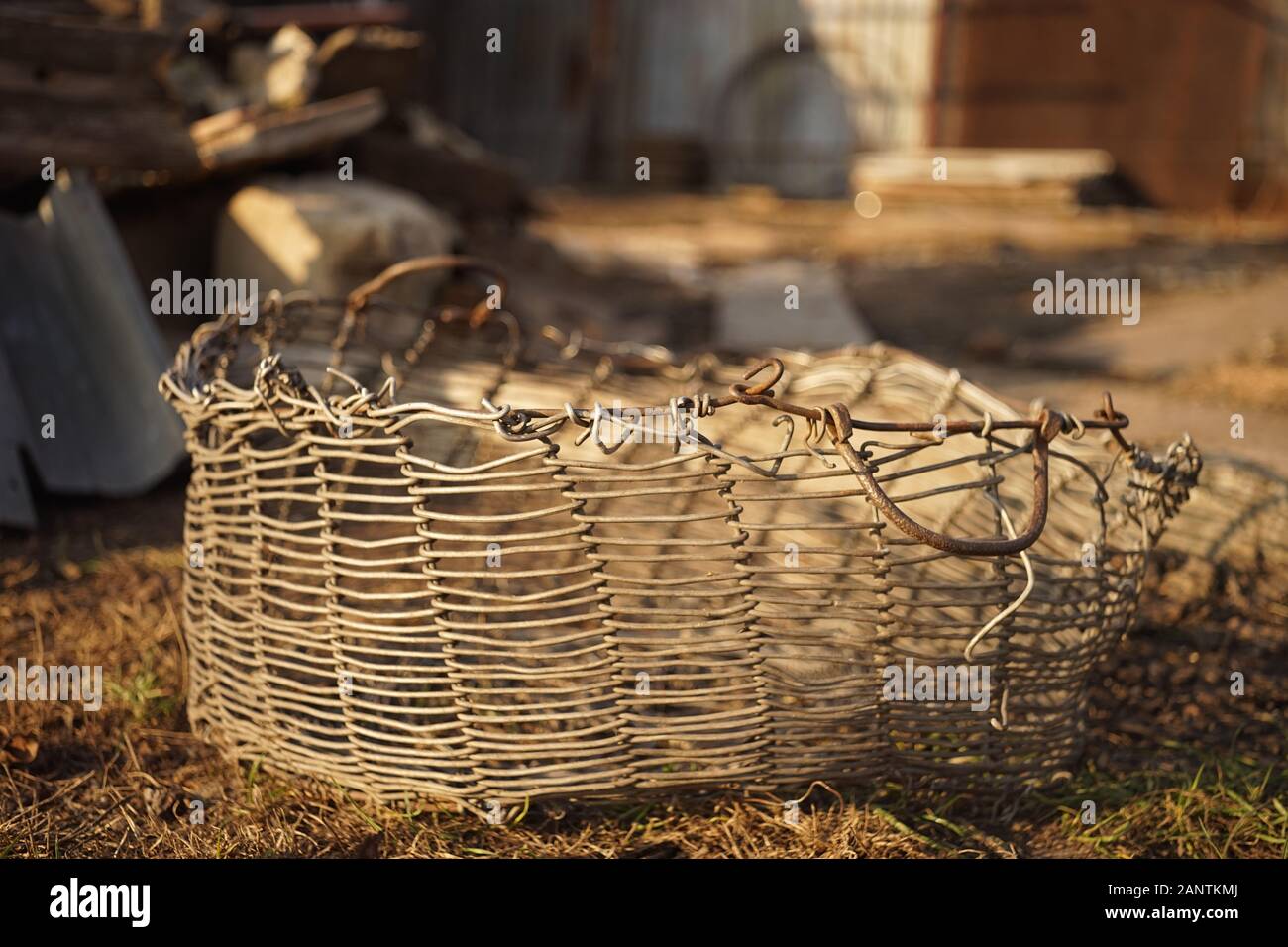 Old wicker basket made of aluminum wire in a rural yard Stock Photo - Alamy
