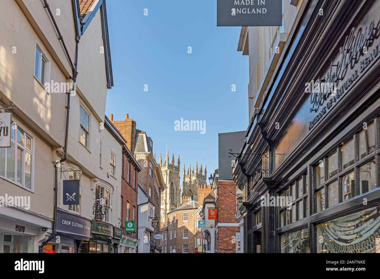 Low Petergate in York with its shops and the towers of York Minster in ...