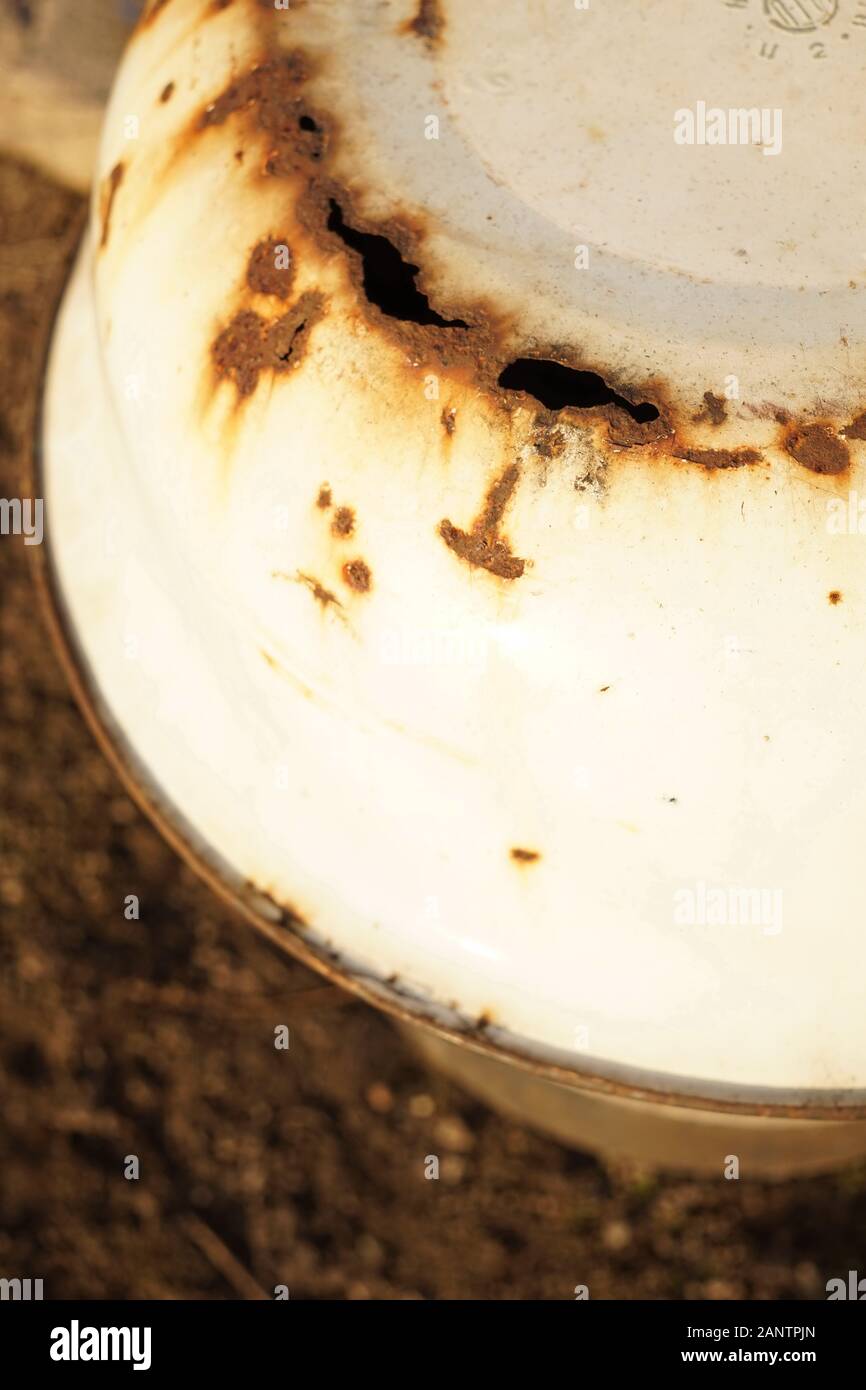 Old enamel bowl with pieces of rust and holes Stock Photo - Alamy