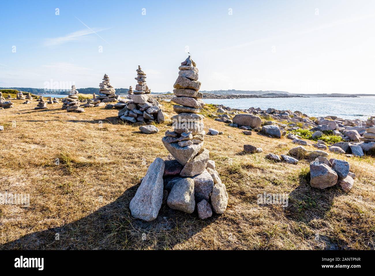 Many man-made granite stone stacks (called cairns) on the coastal path ...