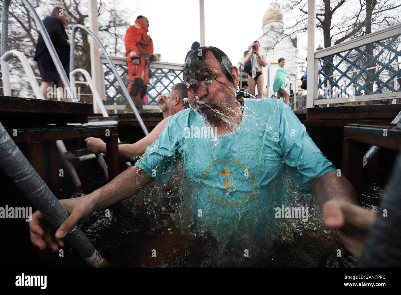 Orthodox Christians dive into iced water during the Epiphany ...