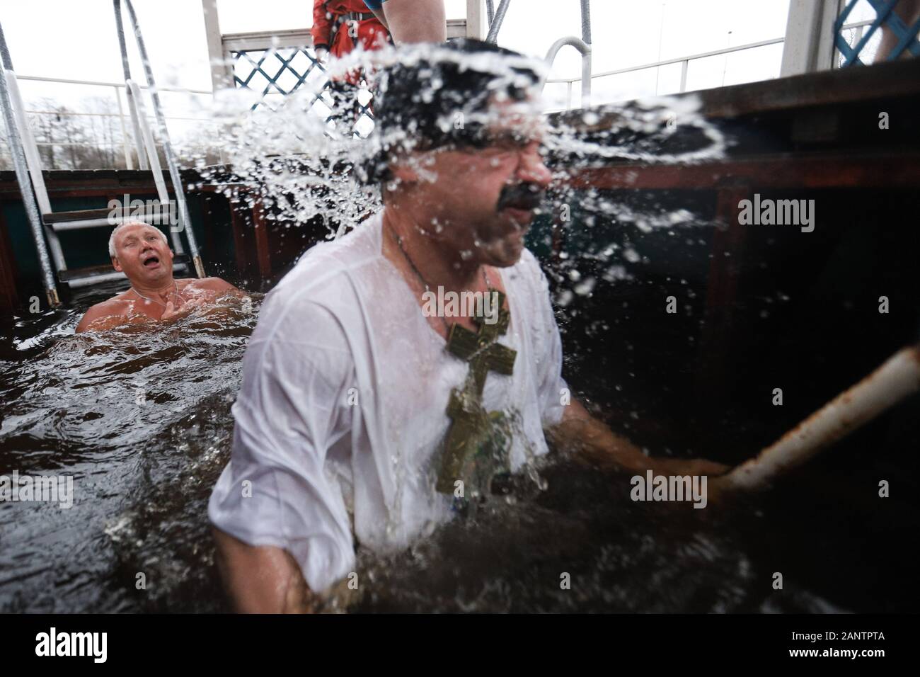 Orthodox Christians dive into iced water during the Epiphany ...