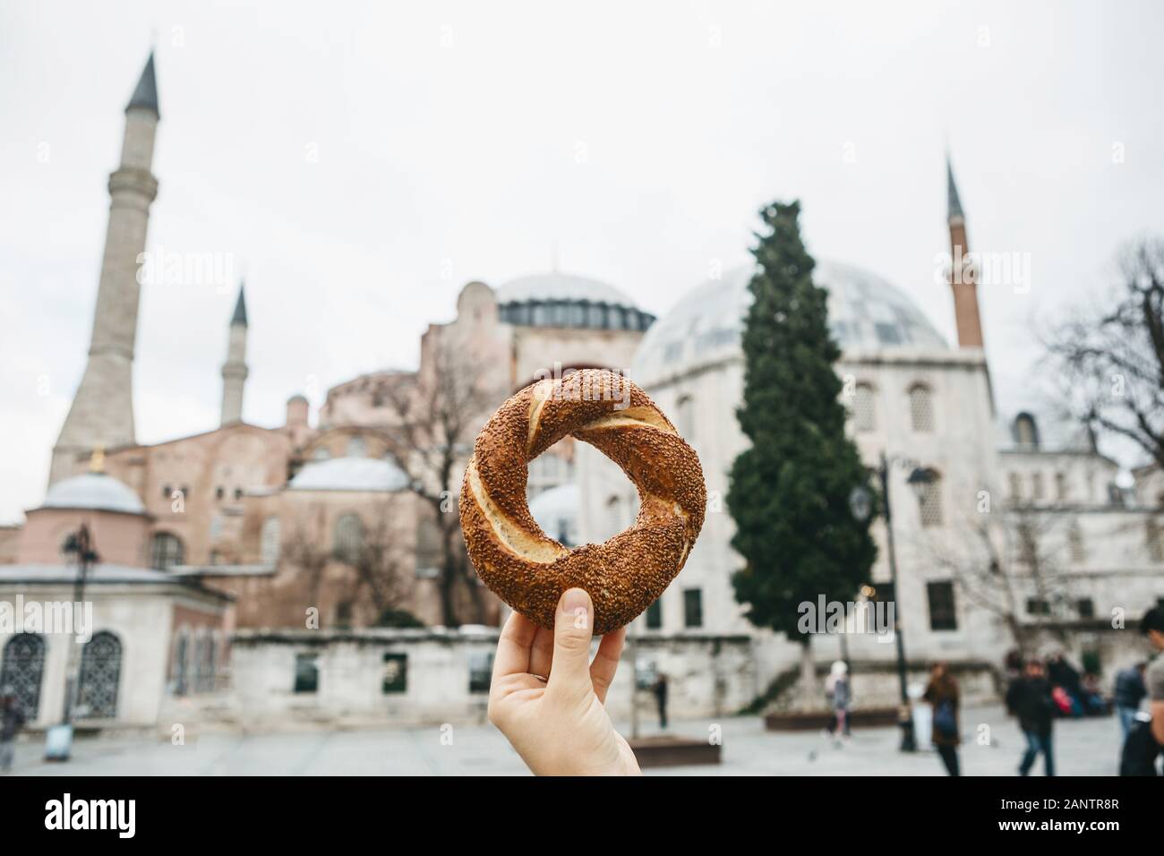 A person holds a traditional Turkish pretzel Simit against the ...