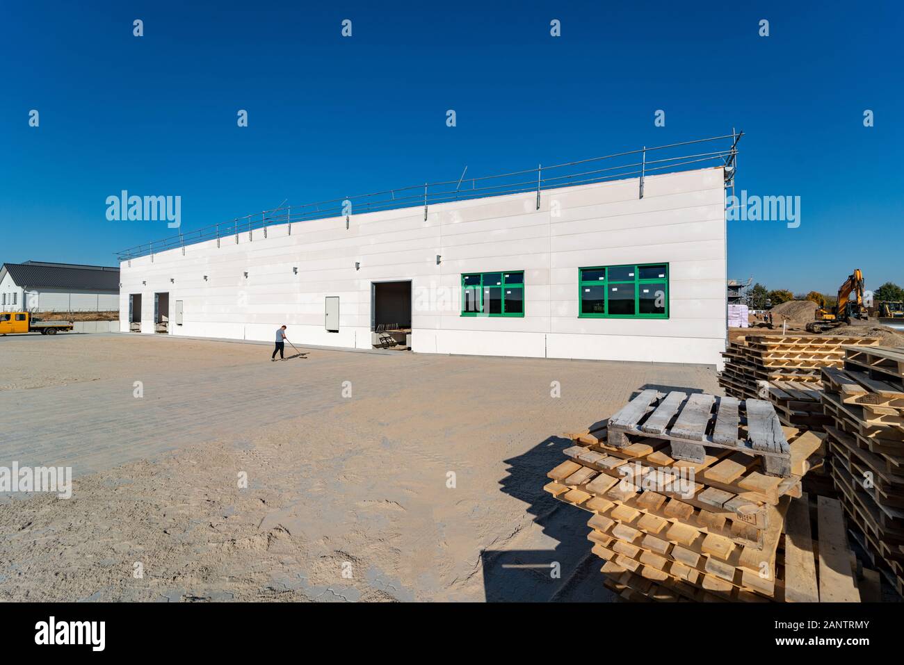 on a building site the outdoor area of a large factory building is ...