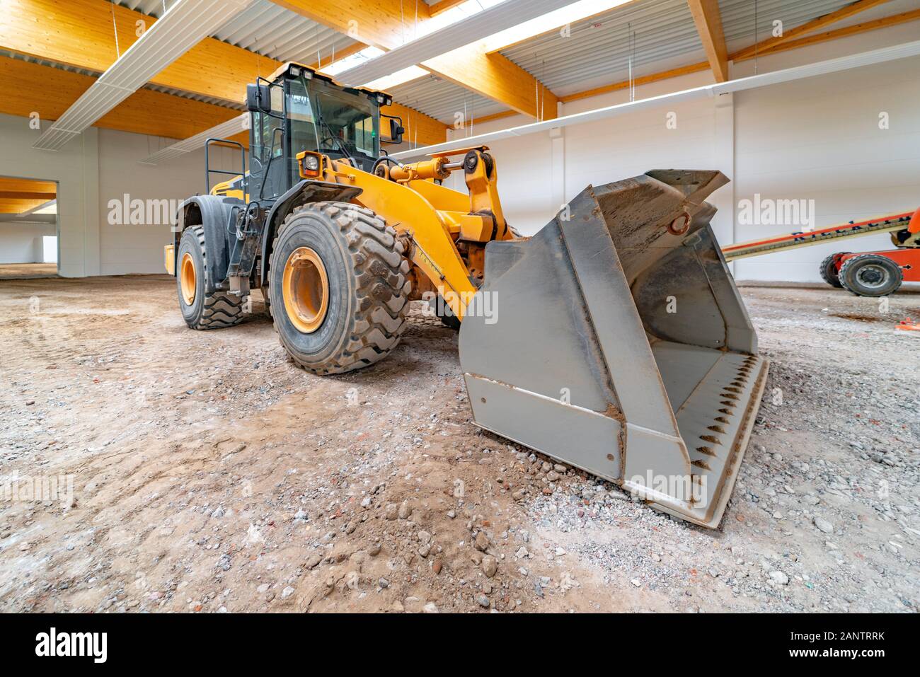 Inside a large factory hall are two large construction machines Stock ...