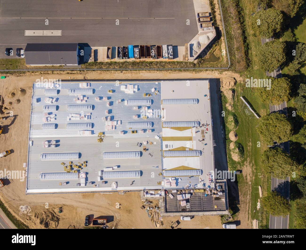 Insulation is installed on the roof of a newly built factory building ...
