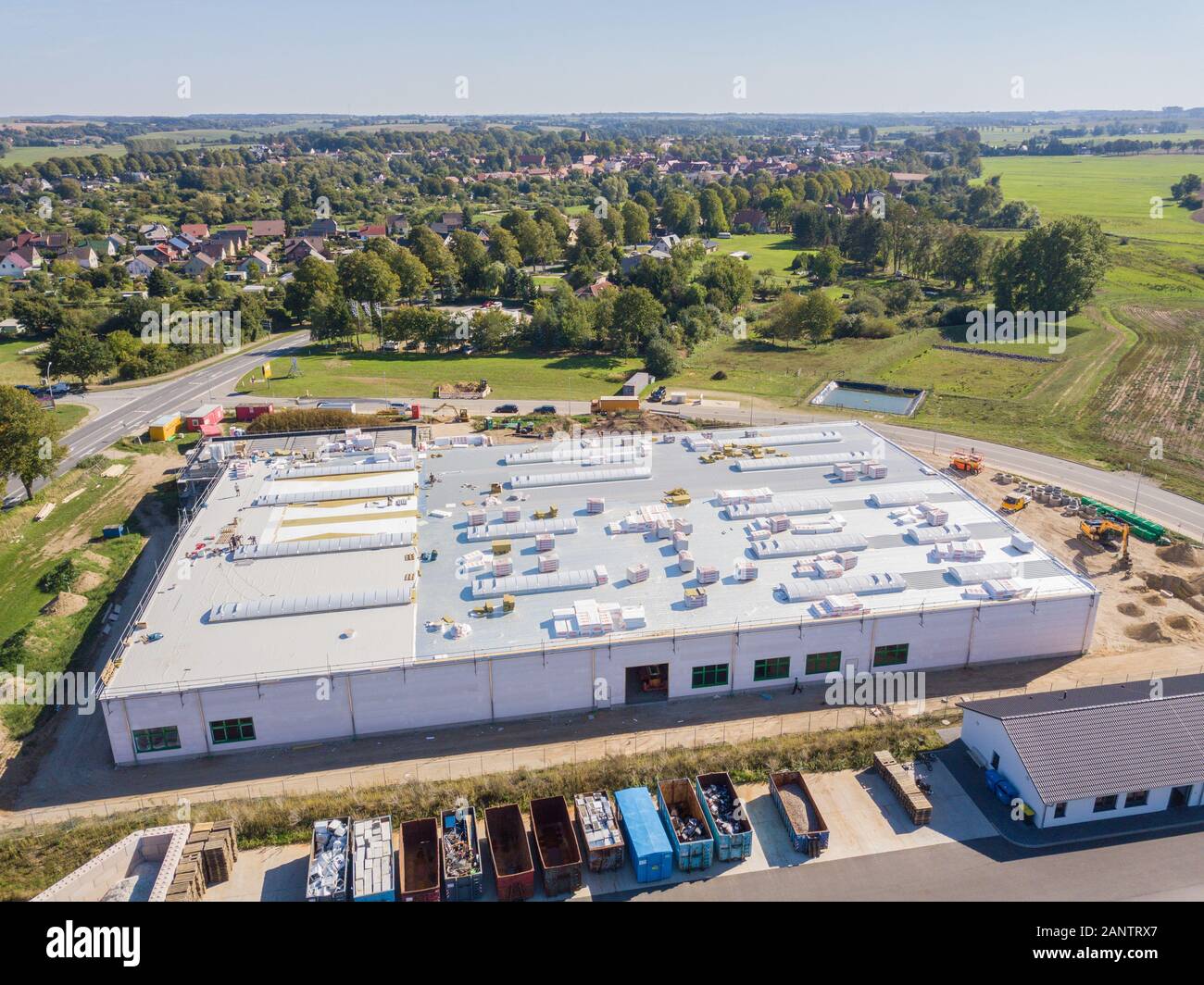 Insulation is installed on the roof of a newly built factory building ...