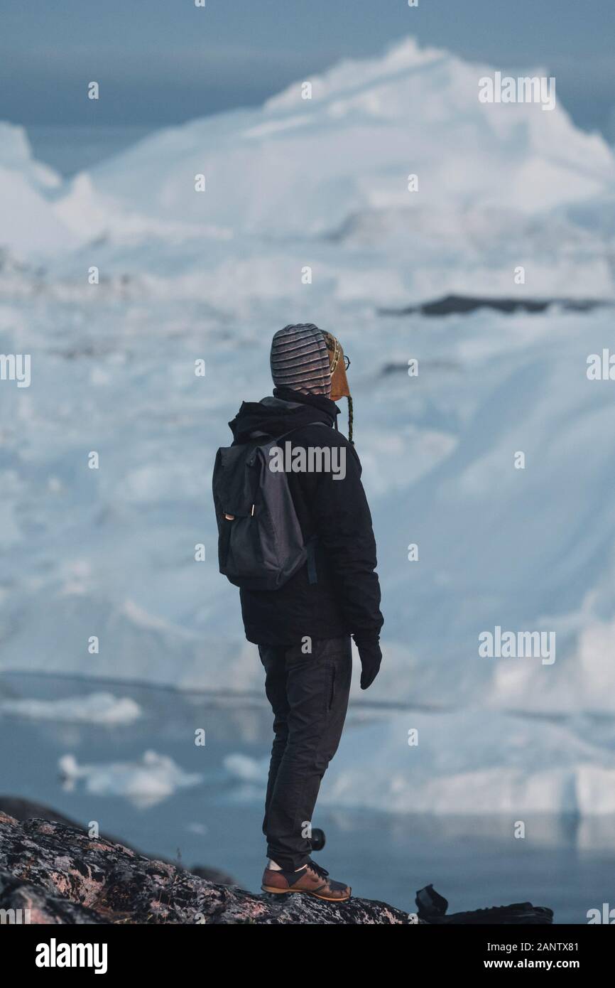 Greenland tourist man explorer overlooking Icefjord in Ilulissat ...