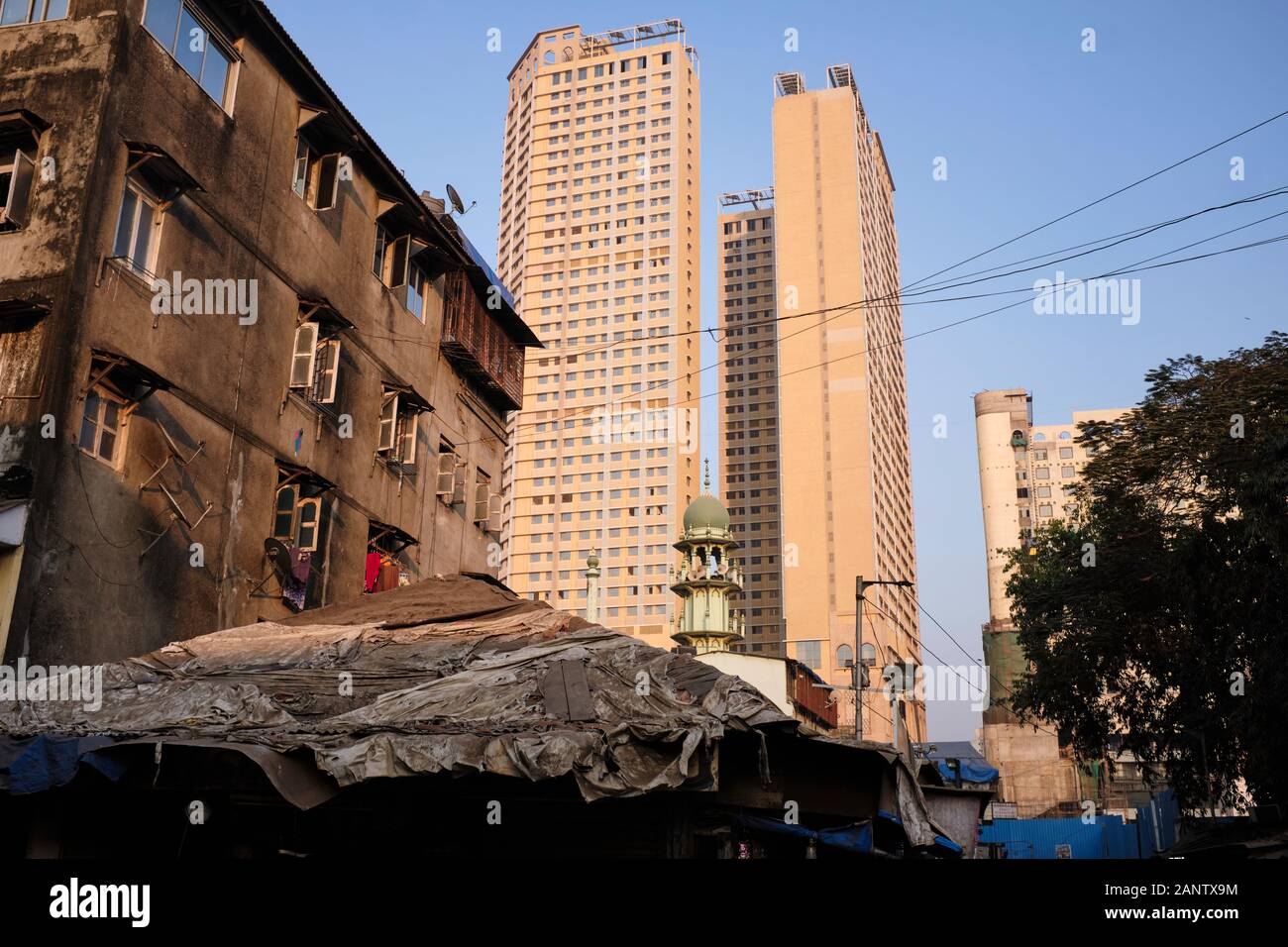 New high rise apartment buildings towering over a mosque and and older ...