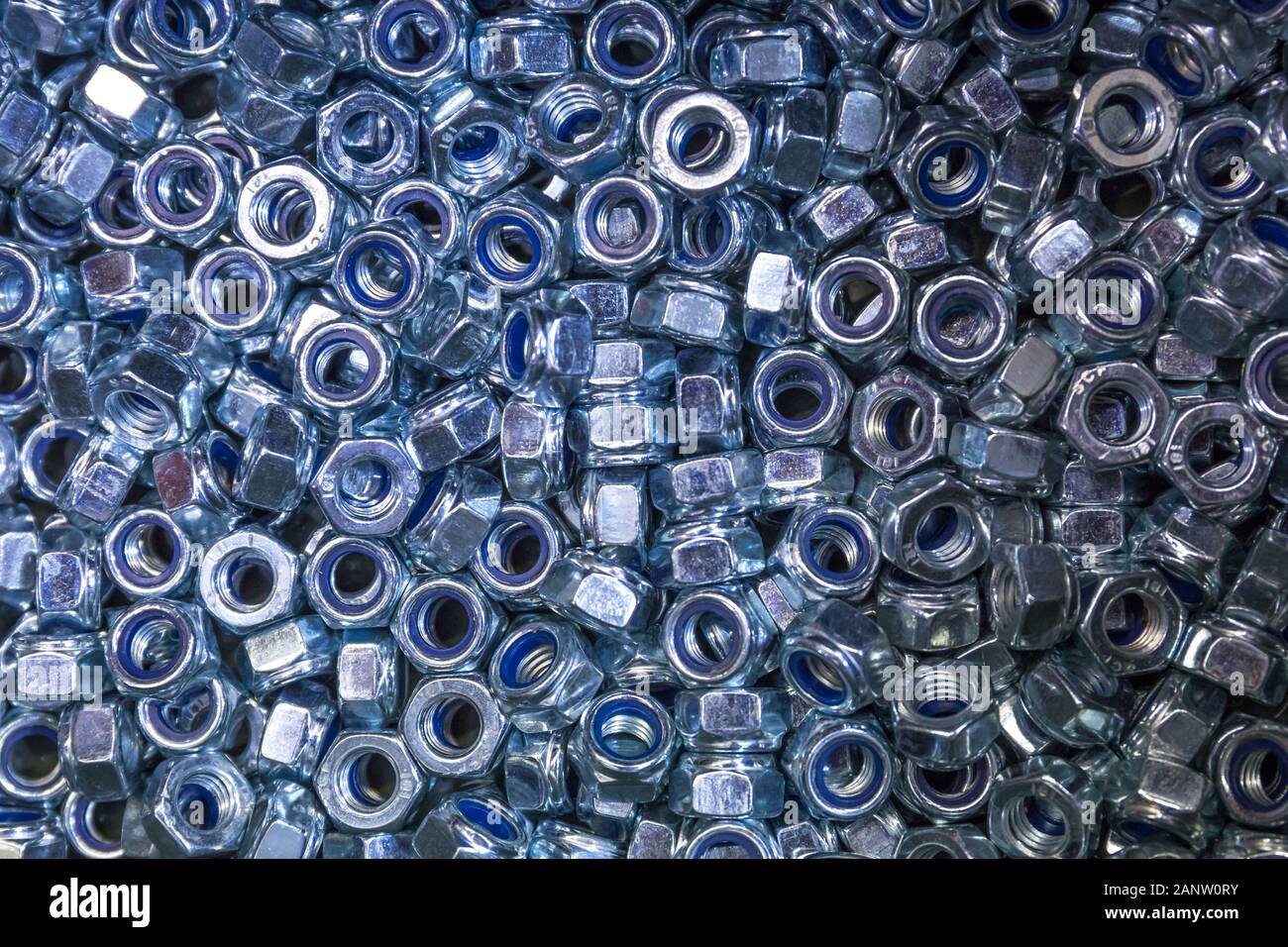 A pile of galvanized industrial nuts. Metal nut texture, industrial ...