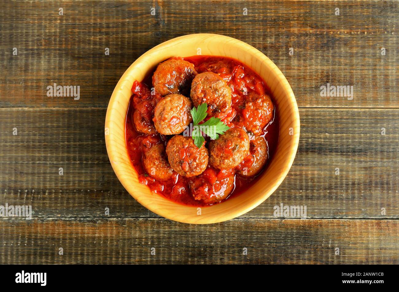 Fried meatballs in tomato sauce in wooden bowl. Top view, flat lay ...