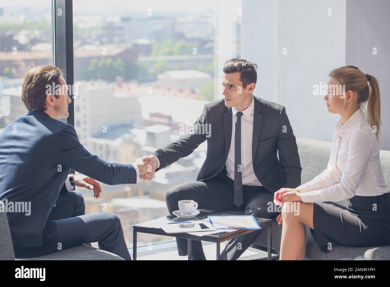 Interviewer handshaking the applicant hi-res stock photography and ...