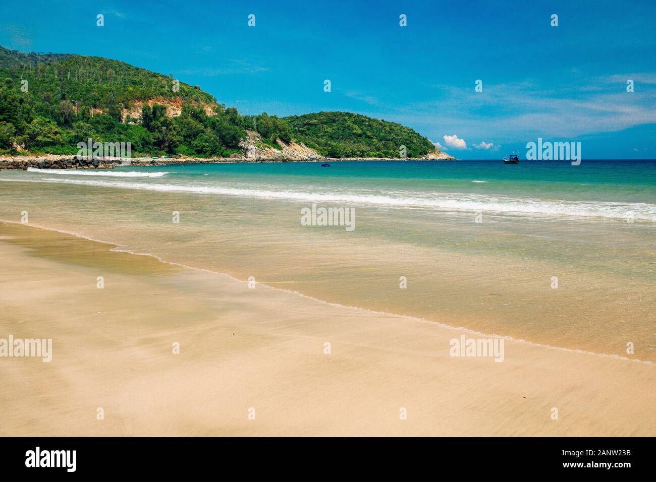 Beautiful, empty tropical white sand beach, small waves in the sea ...