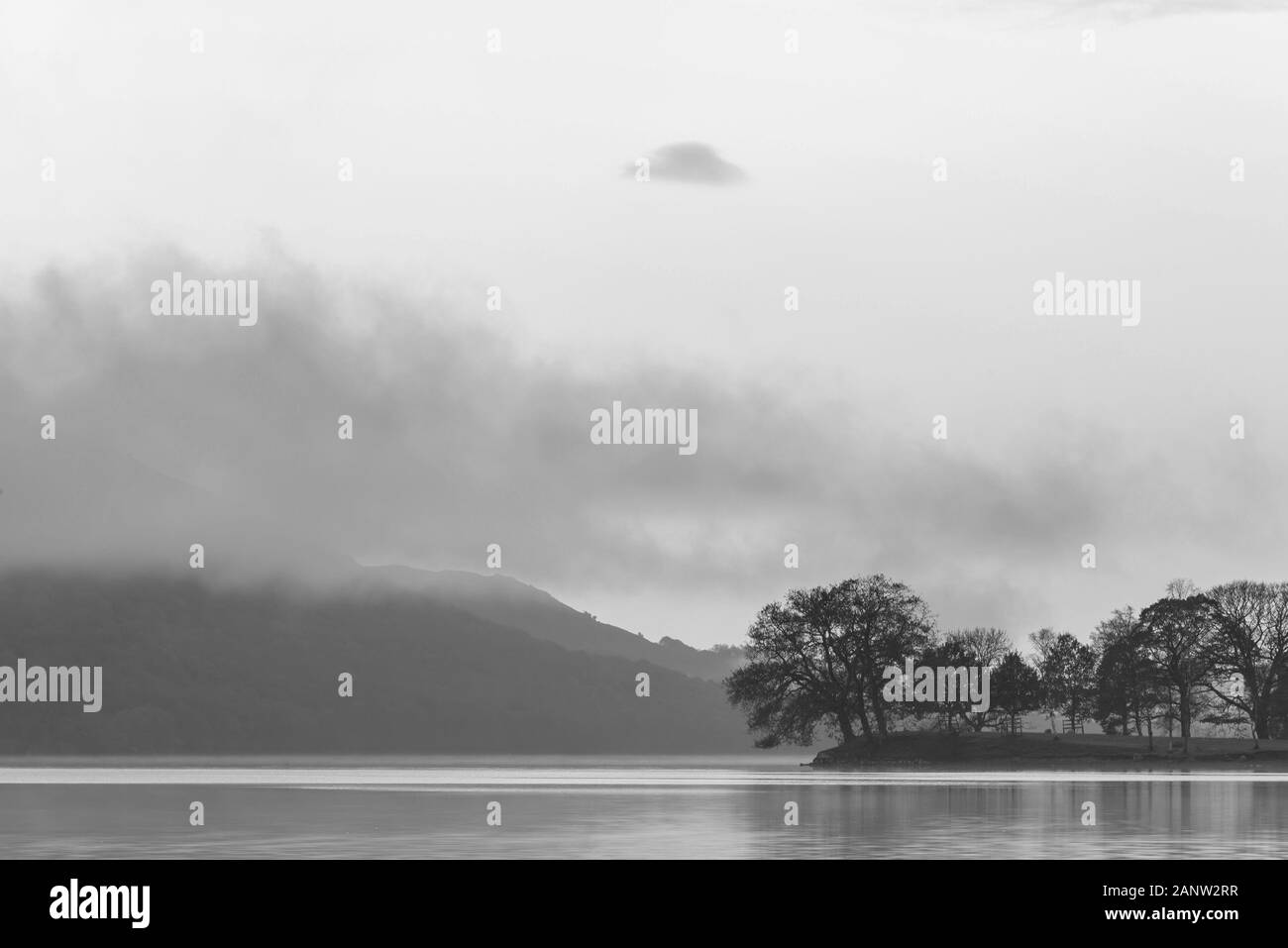 Beautiful sunrise landscape over Coniston Water during Autumn with mist ...