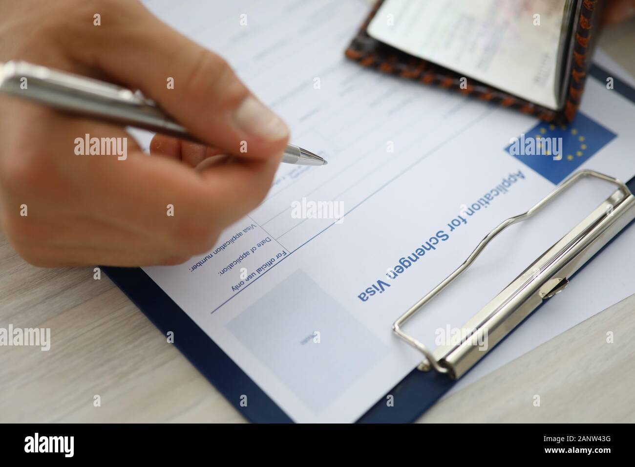 Man writing down personal information Stock Photo - Alamy